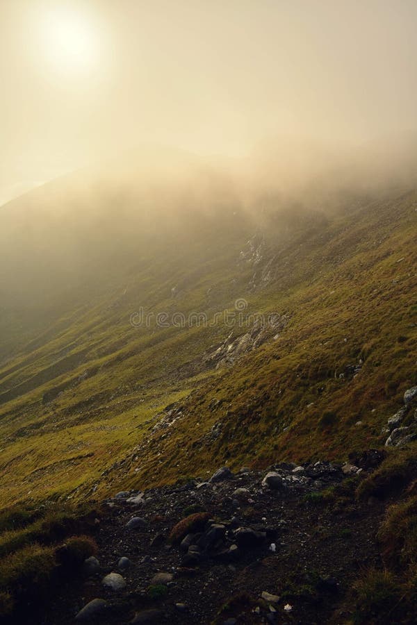 The Sun Filtered through the Clouds and the Fog in the Mountains Stock ...