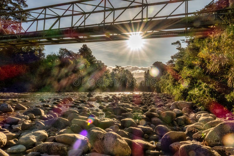 Sun Flare and Colourful Orbs at Sunset Under the Bridge Stock Photo ...
