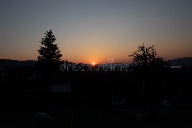 Sun Going Down Behind the Horizon Stock Photo - Image of dawn, tree ...