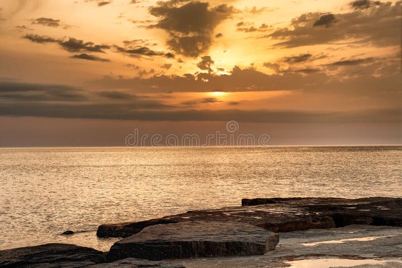 Sun Going Down Over the Water Glowing on the Shore Stock Photo - Image ...