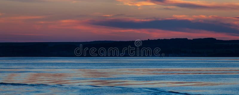 The Sun Gracefully Dips Below the Horizon, Casting a Warm and Tranquil ...