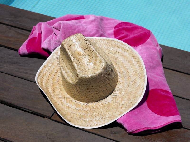 Sun Hat and Beach Towel by Swimming Pool Stock Photo - Image of blue ...