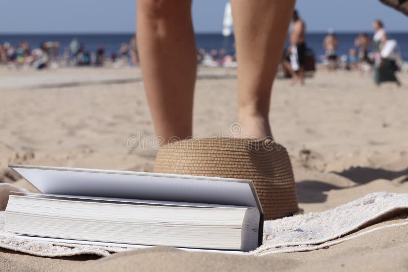 A Sun Hat with a Book To Read in the Beach Sand Stock Image - Image of ...