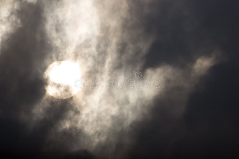 Sun behind grey clouds stock image. Image of factory - 196594297