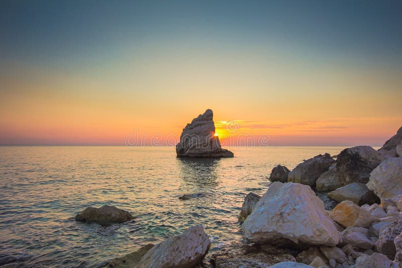 Sun hide behind the rock stock photo. Image of coast - 57061066