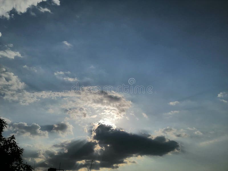 Sun Hiding in between Clouds Stock Photo - Image of burst, faded: 193297288