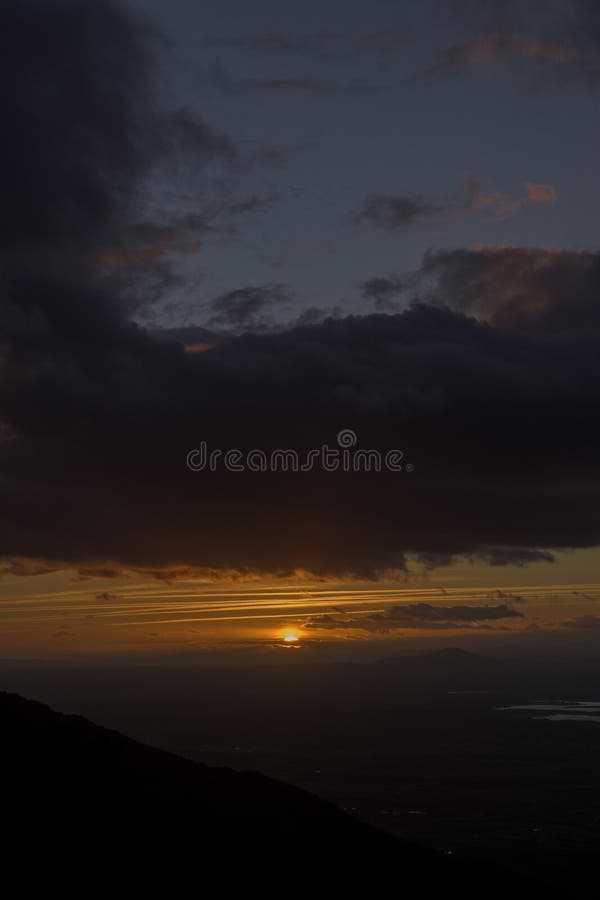 Sun Hiding on the Horizon with Reddish and Orange Tones at Sunset ...