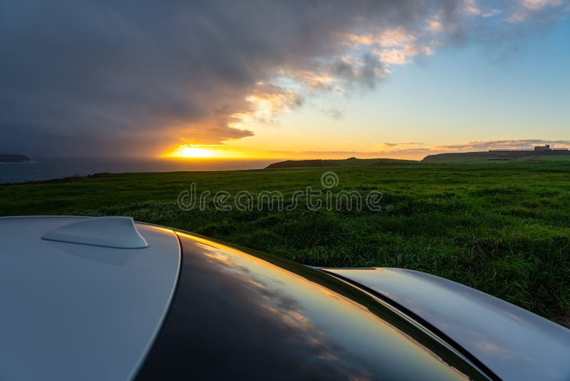 The Sun Hiding Over the Horizon at Sunset and Reflecting the Light on ...
