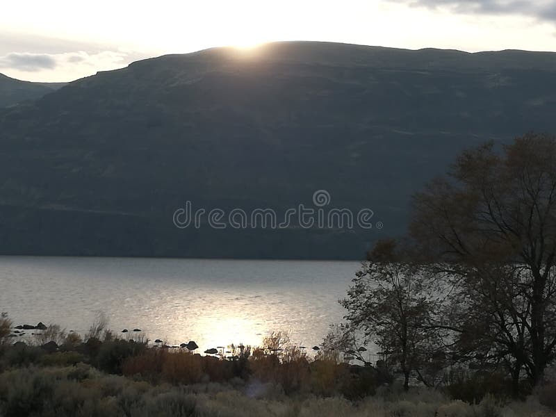 Sun, hill lake tree sky stock photo. Image of hill, tree - 176754350
