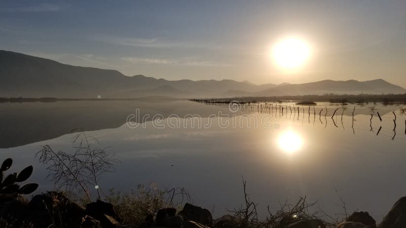Sun in the lake stock image. Image of rising, mountains - 117094623