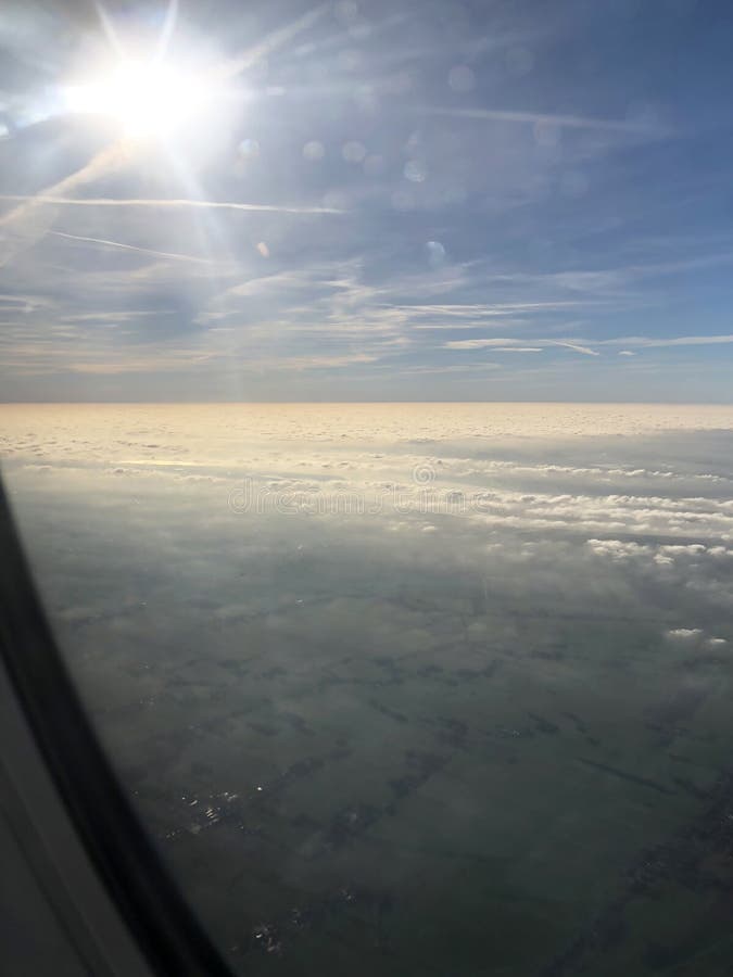 Sun Lens Flare and Clouds from Plane Window Stock Photo - Image of ...
