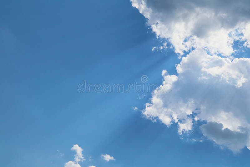 Sun Light Rays or Beams Bursting from the Clouds on a Blue Sky. Rays of ...