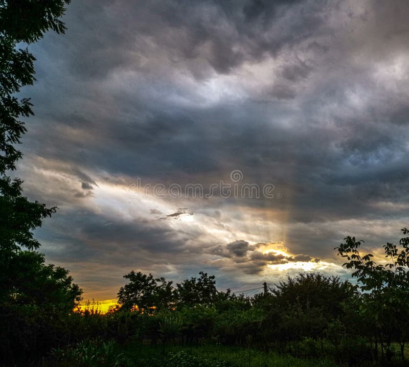 Sun Light Striking through Heavy Clouds Stock Photo - Image of striking ...