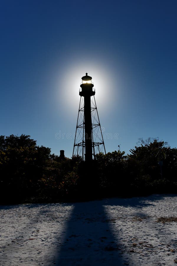 Sun lit lighthouse stock photo. Image of beach, sand - 18431074