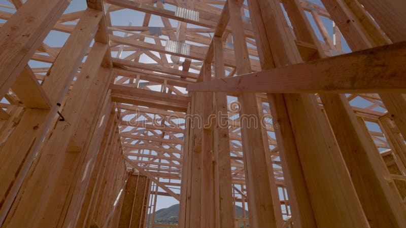 Sun Lit Slow Motion Pan of New Home Wood Framing Construction Site ...
