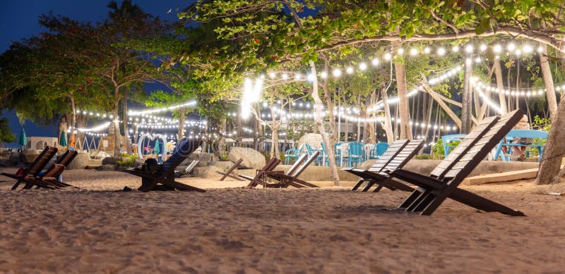Sun Loungers on the Sandy Beach in the Light of Lanterns at Night Stock ...