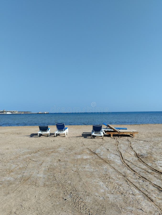 Sun Loungers Stand on a Deserted Beach, an Empty Beach Coast without ...