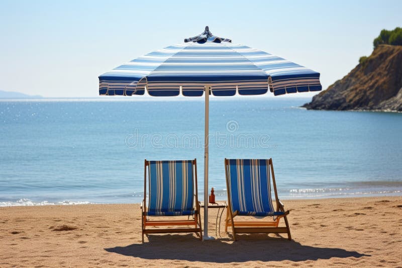 Sun Loungers Under a Parasol on a Beach Facing the Sea Stock Image ...