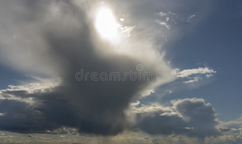The Sun Making Its Way through the Rain Cloud Stock Image - Image of ...