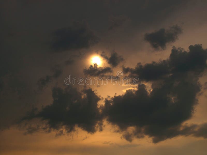 The Sun in the Middle of the Orange Sunset Sky with Dark Thunderstorm ...