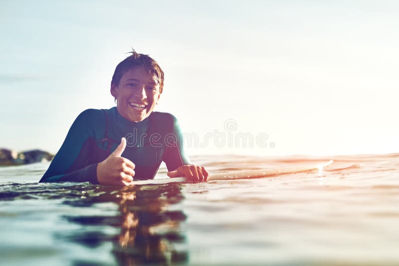 Sun is Out, Surfs Up. Shot of a Young Boy Out Surfing. Stock Image ...