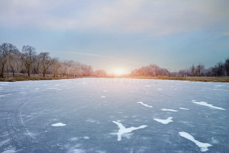 The Sun Over a Frozen Lake on a Winter Evening Stock Photo - Image of ...