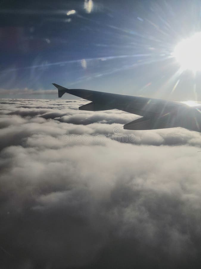 Sun over plane wing stock image. Image of clouds, wing - 170514751