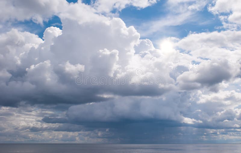 Sun over a rain cloud stock image. Image of shiny, ocean - 41060217