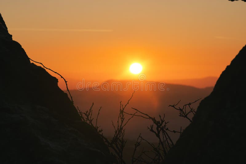 Sun Peaking between Two Rocks at Winter Solstice Stock Photo - Image of ...