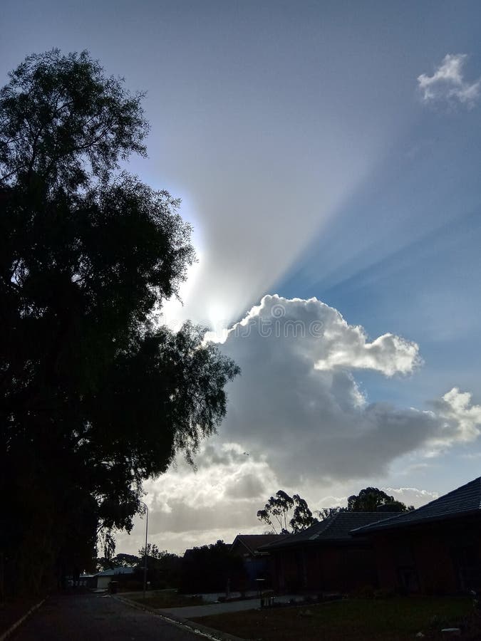 Sun Peeking Through The Clouds As It Rises Over Lake Peninsula Stock ...