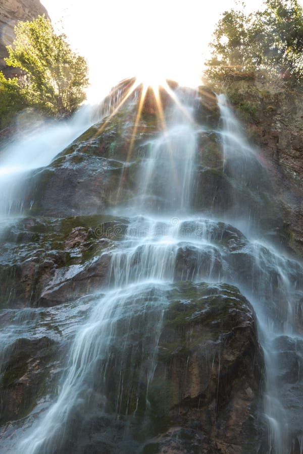 Sun Peeking Out Above Waterfall with Long Exposure Stock Photo - Image ...
