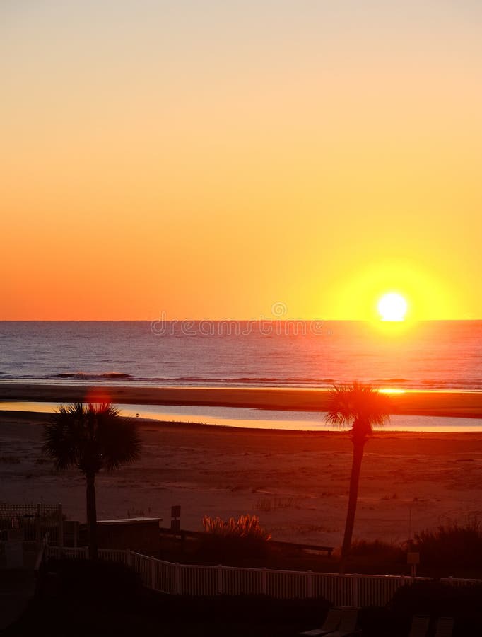 Sun Peeking Over the Horizon Stock Photo - Image of color, sunrise ...