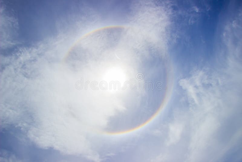Sun with Rainbow Ring Around it with Blue Sky and Clouds Stock Image ...