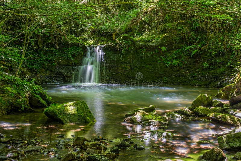 Sun Ray Lights Over a Small Waterfall in a River in Galdames, Basque ...
