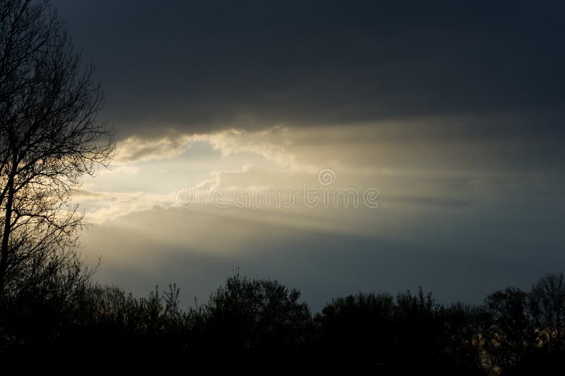 Sun Rays Against the Background of Gray Rain Clouds at Sunset Stock ...