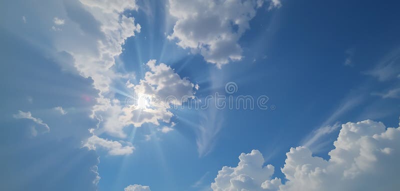 Sun Rays Beaming through Fluffy Clouds in Bright Blue Sky with Stock ...