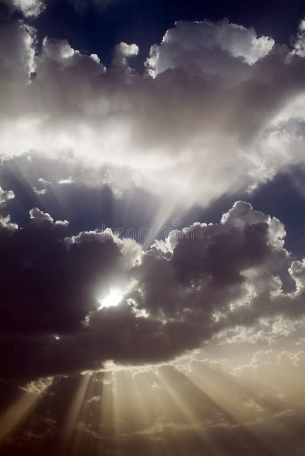 Sun rays behind clouds stock image. Image of storm, light - 1167285