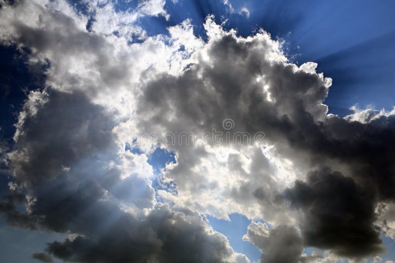 Sun rays behind clouds stock photo. Image of meteorology - 53716866