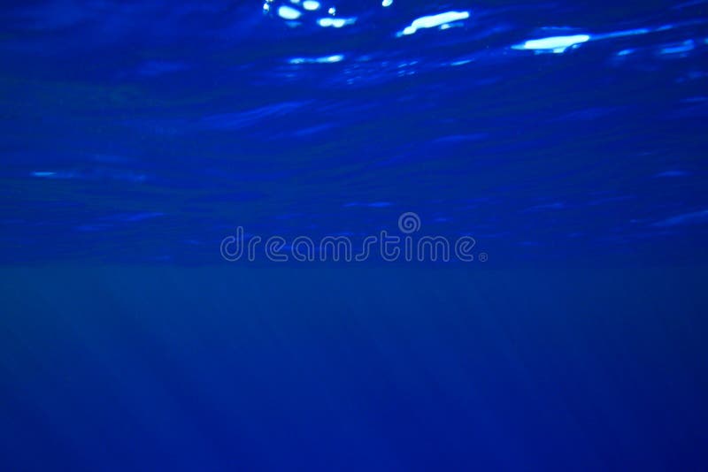 Sun rays in blue water stock photo. Image of texture - 15075914