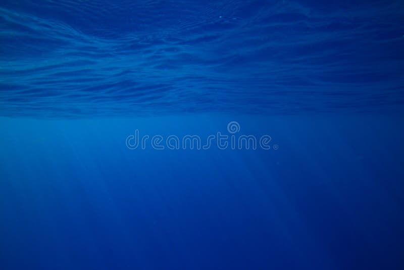 Sun rays in blue water stock photo. Image of texture - 15075914