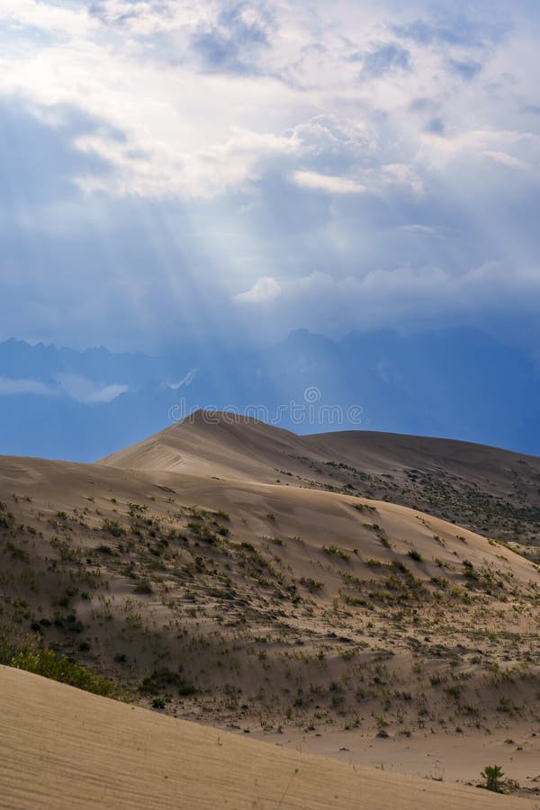 Sun Rays Breaking through Clouds Over Desert Dunes Stock Photo - Image ...