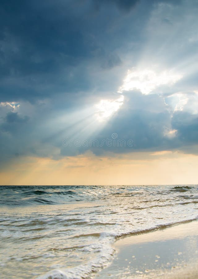 Sun Rays Breaking through the Clouds at Sunset Stock Photo - Image of ...