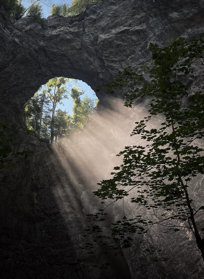 Sun rays through cave hole stock photo. Image of cave - 227880126