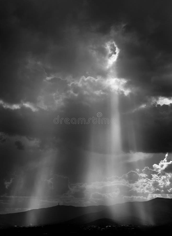 Sun Rays in Clouds and Mountains Dark and Stormy with Shafts of Light ...