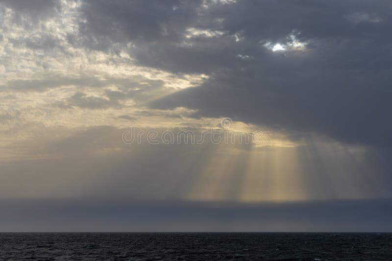Sun Rays and Clouds Over the Sea Stock Image - Image of rainbow, dusk ...