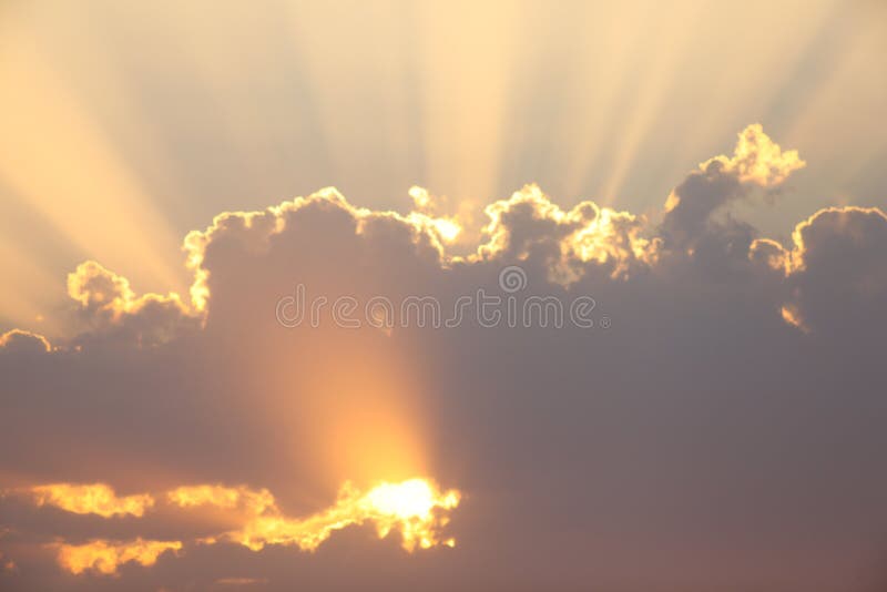 Sun Rays through the Clouds at Sunset Stock Photo - Image of glowing ...