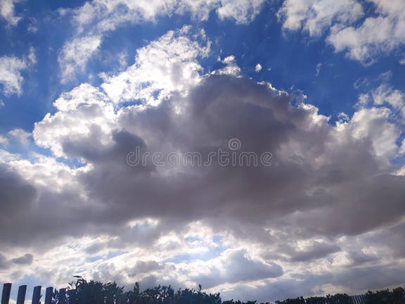 Sun Rays Coming from Behind Heavy Dark Clouds Stock Image - Image of ...