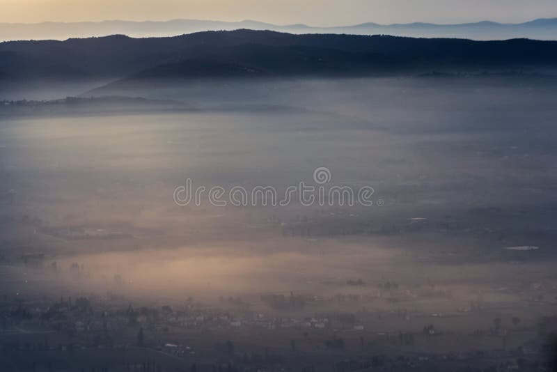 Sun Rays Coming Down from Some Clouds Over a Valley Filled by Fog ...