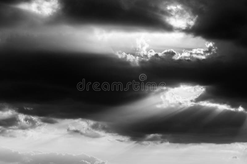 Sun Rays Coming Out through Some Dark Clouds Stock Photo - Image of ...