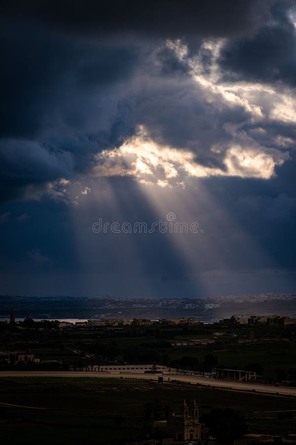 Sun Rays through Dramatic Clouds Over Landscape. Stock Image - Image of view, horizon: 410487909